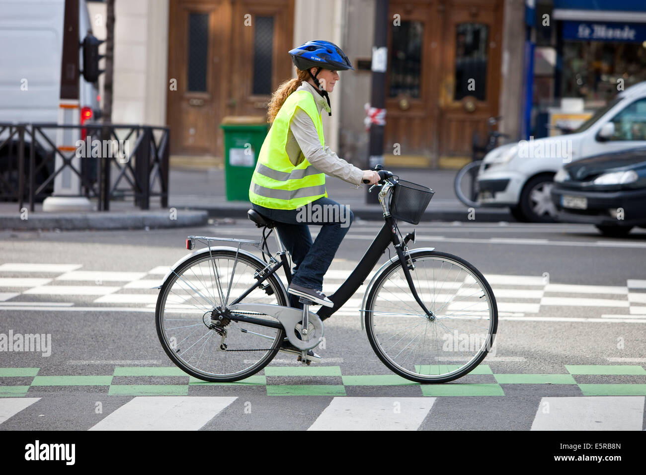 Woman riding a bicyle in a urban environment Stock Photo - Alamy