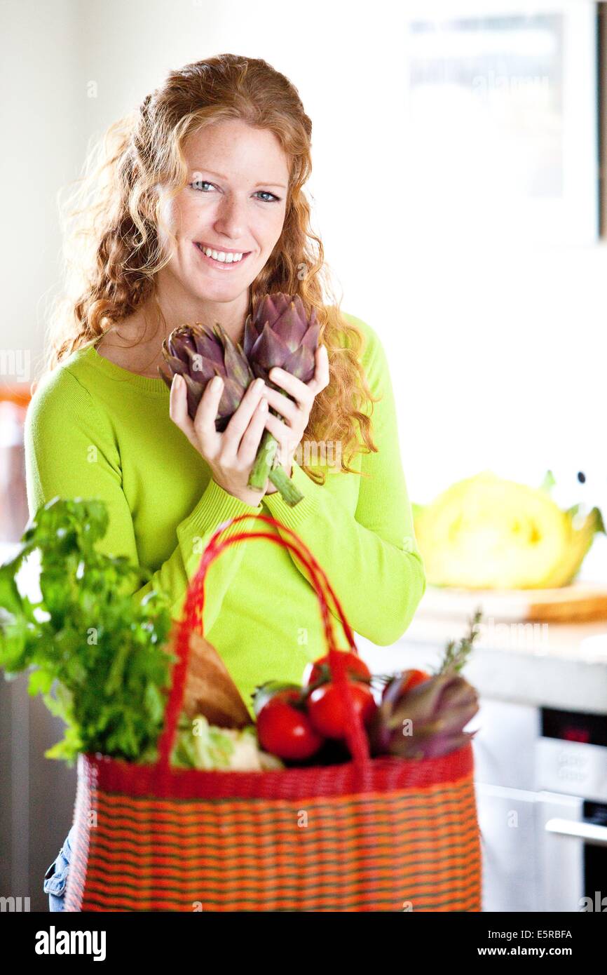 Woman with a basket of vegetables Stock Photo - Alamy