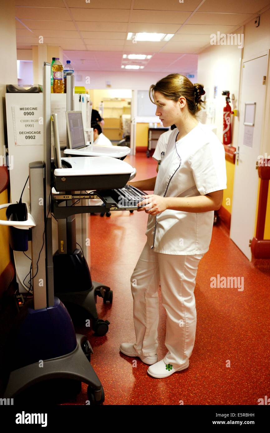 Nurse filling a computerized patient medical records, Emergency ...