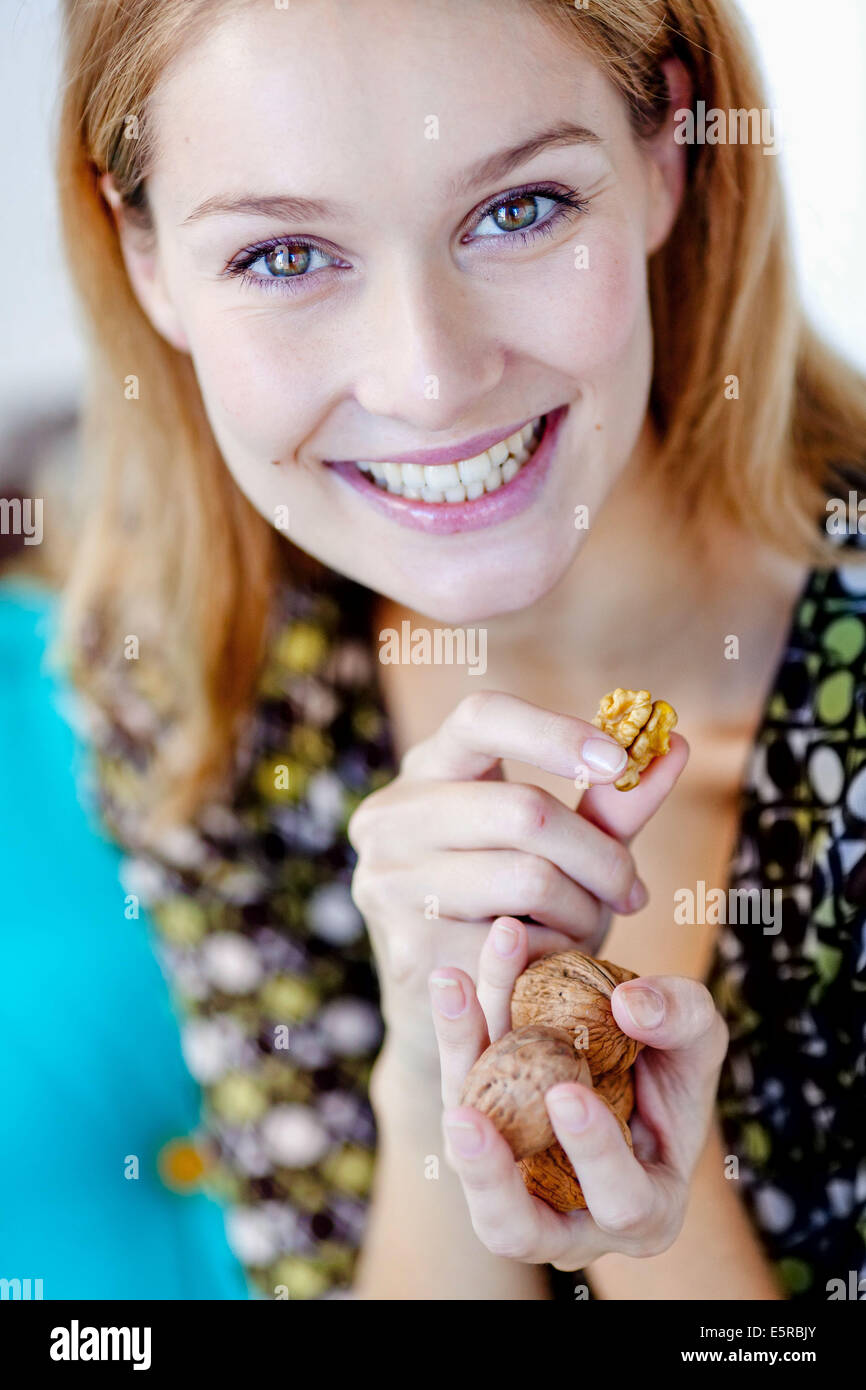 Woman eating walnuts Stock Photo - Alamy
