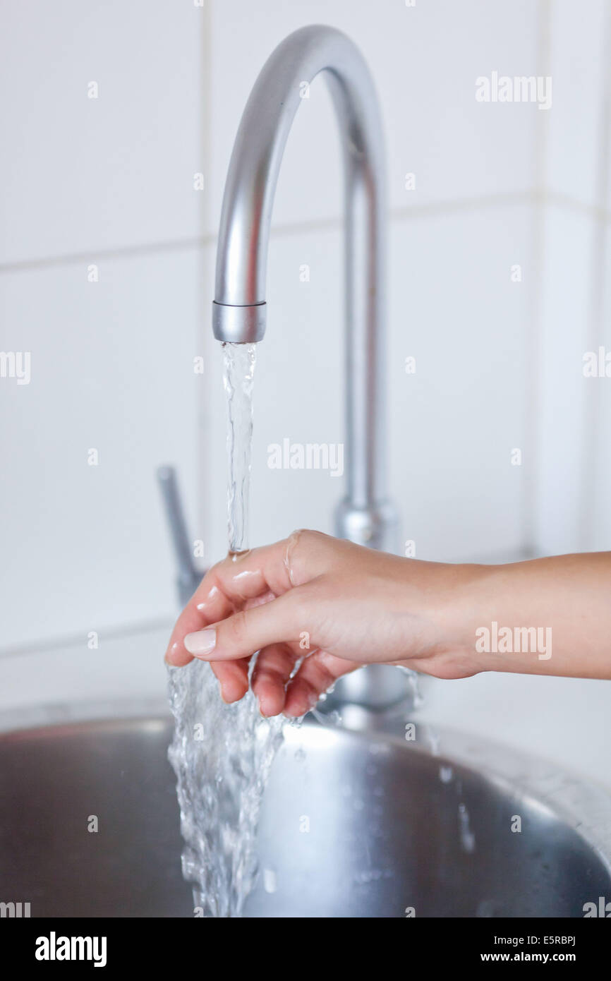 Woman's hand under running water Stock Photo - Alamy