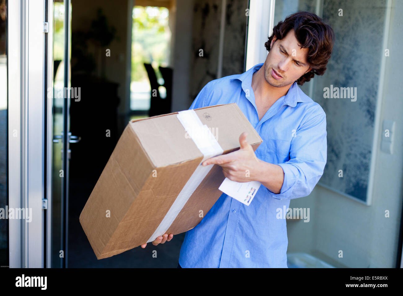 Man receiving package Stock Photo - Alamy