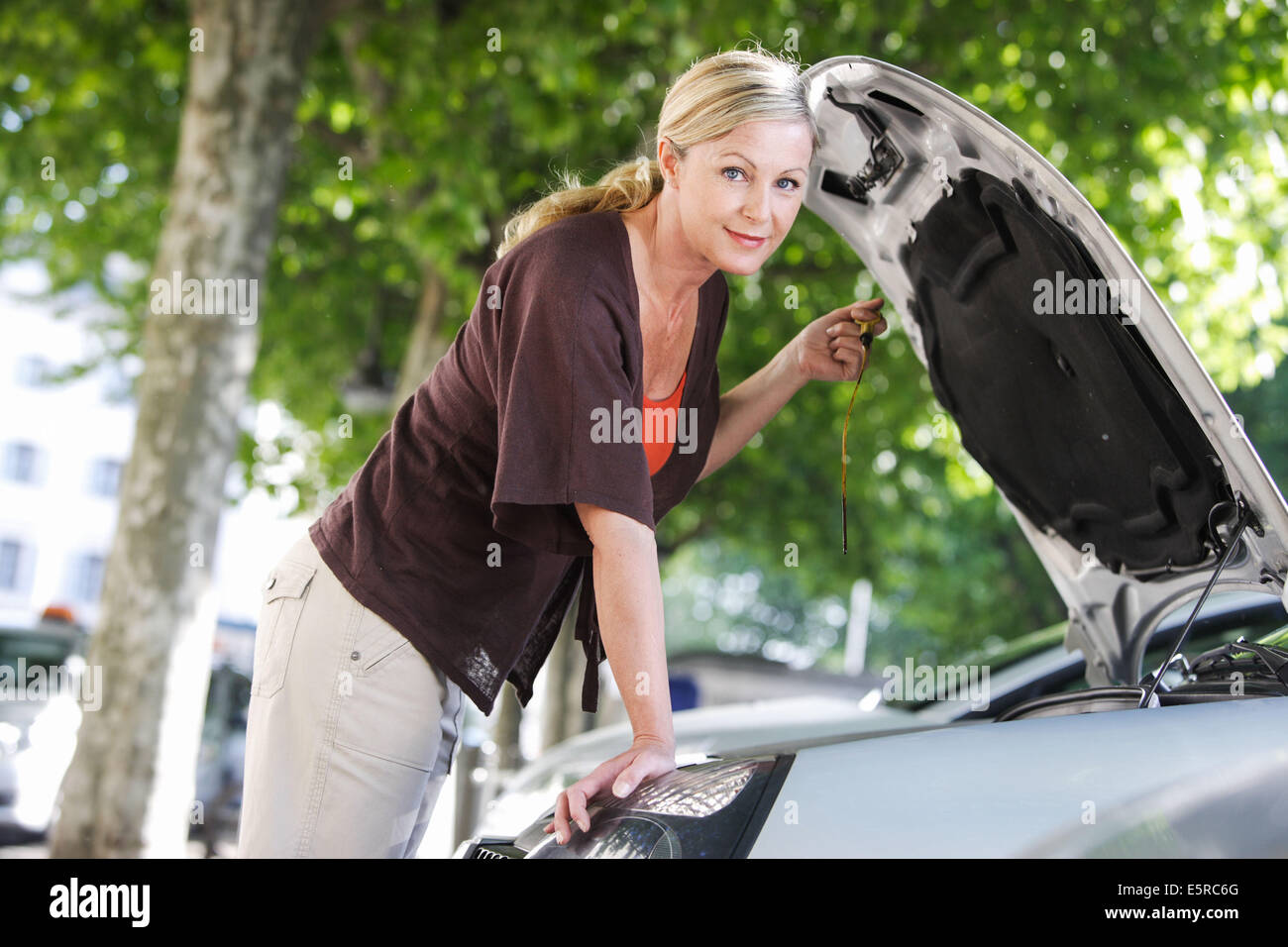 Woman with car trouble Stock Photo - Alamy