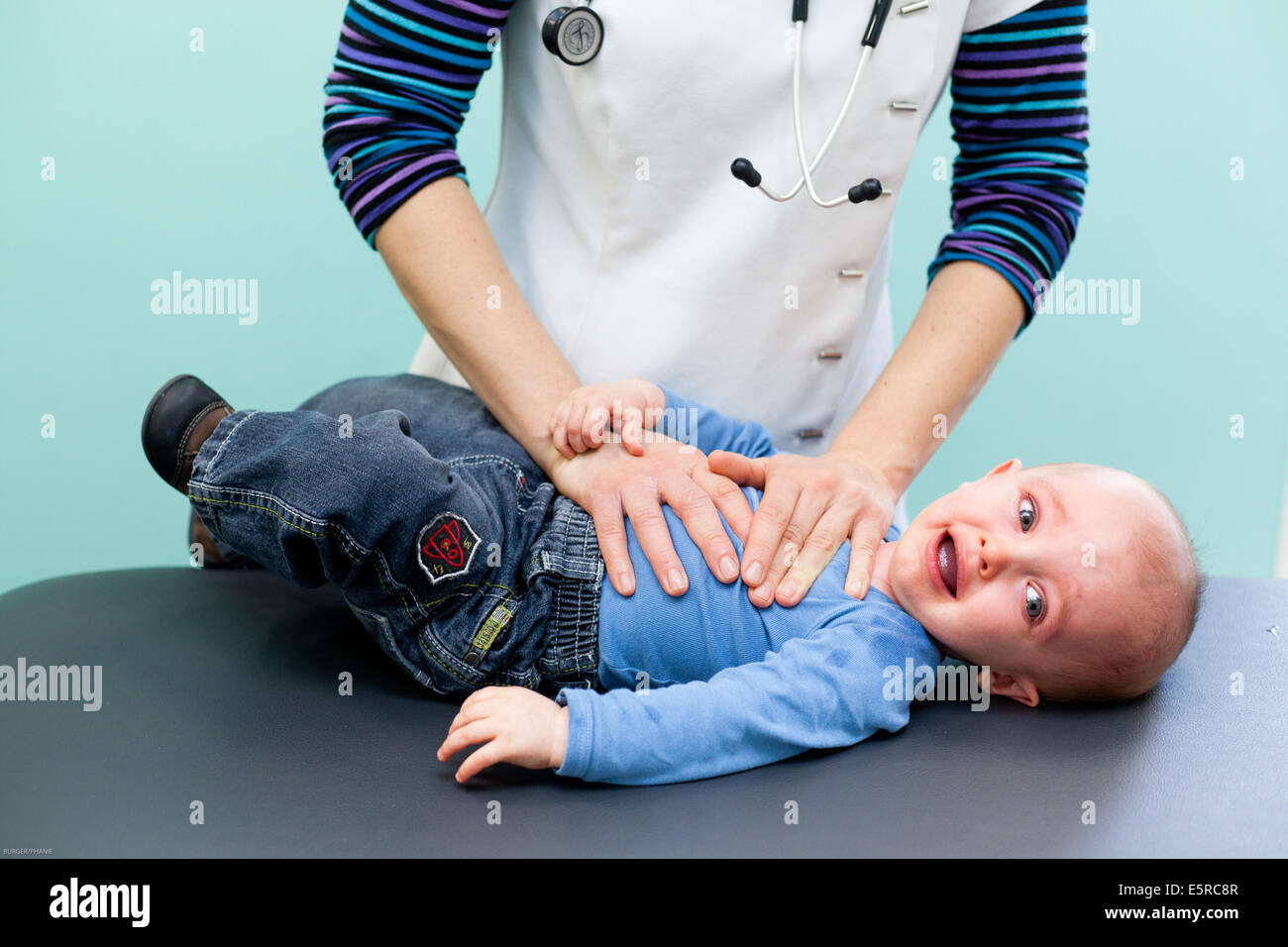Physical Therapist performing respiratory physiotherapy on baby Stock ...