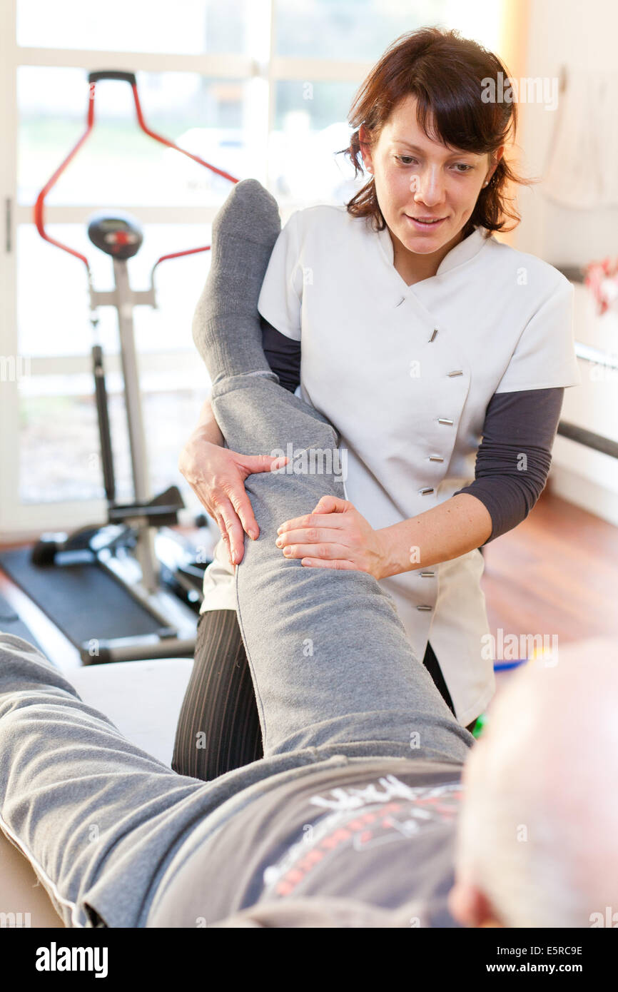 Elderly man physical therapy session with a physiotherapist Stock Photo ...