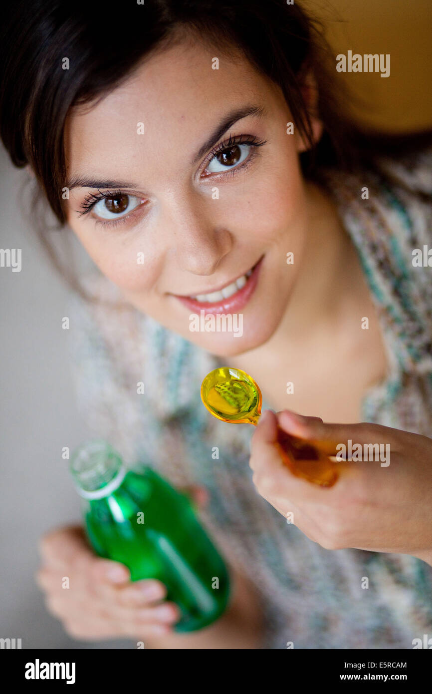 Woman taking syrup Stock Photo - Alamy