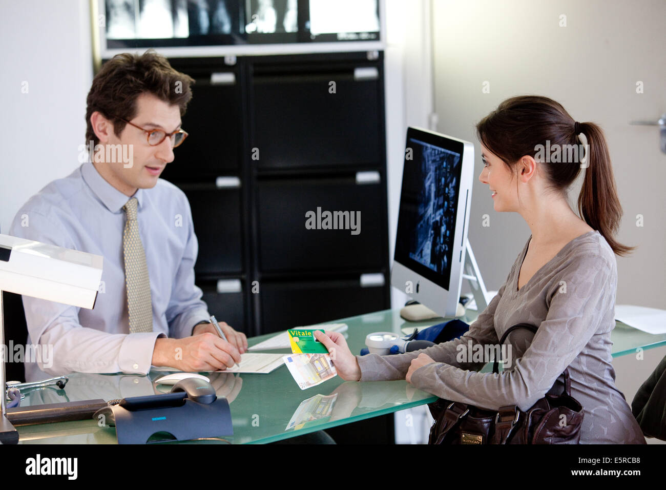 Patient using her health card (Carte Vitale) when paying consultation ...