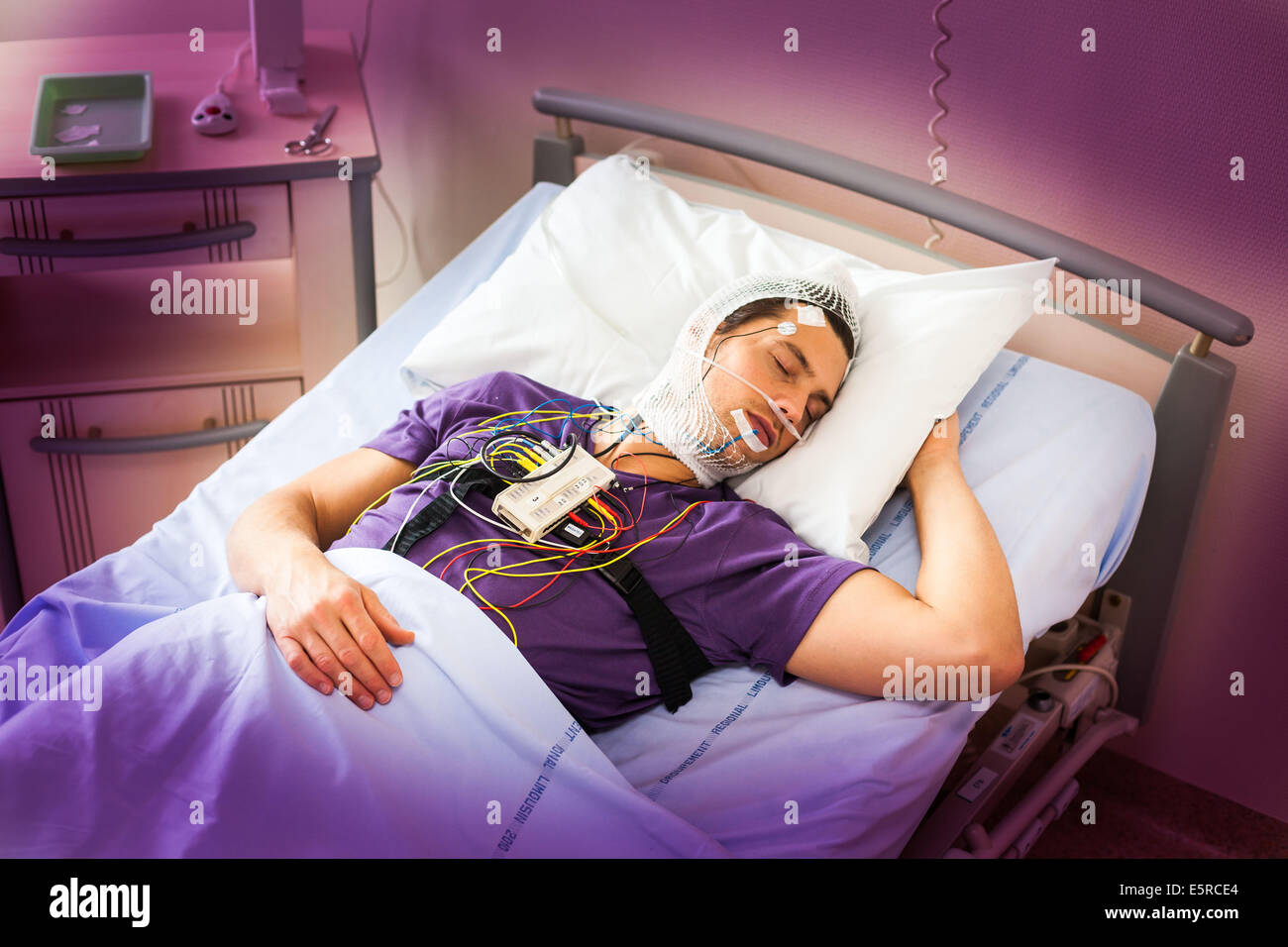 Man undergoing a polysomnographic examination. The polysomnography is ...