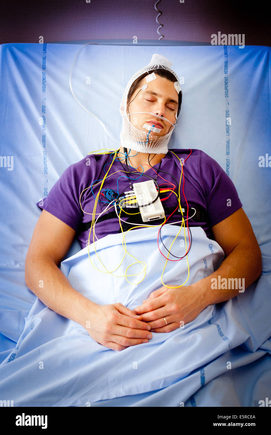 Man undergoing a polysomnographic examination. The polysomnography is ...
