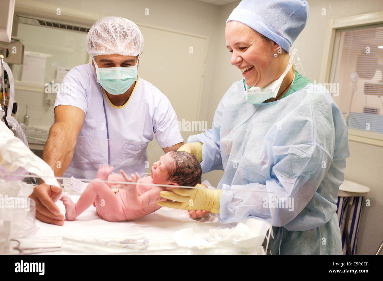 Midwife attending to a newborn baby, Obstetrics and gynaecology ...