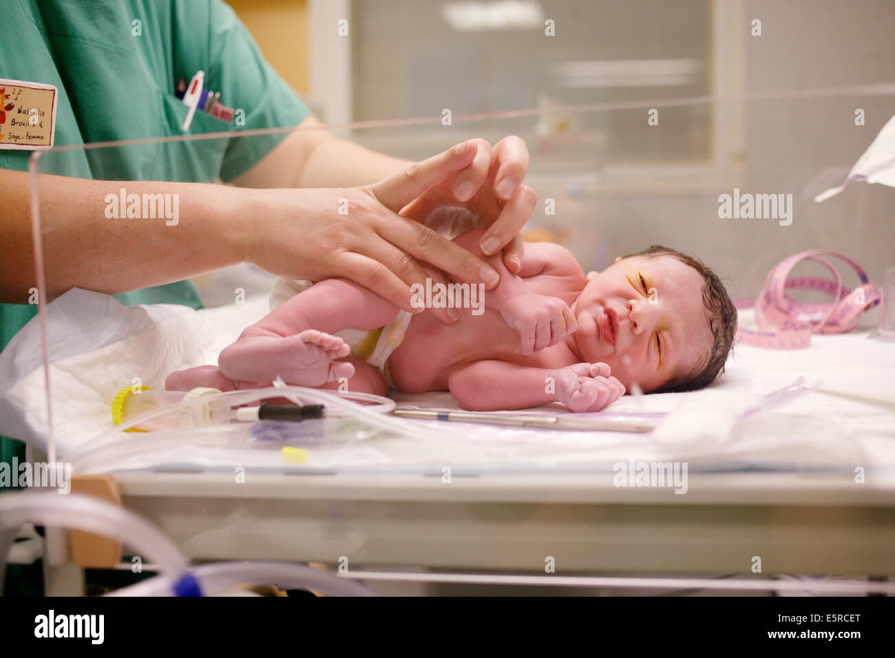 Midwife attending to a newborn baby, Obstetrics and gynaecology ...