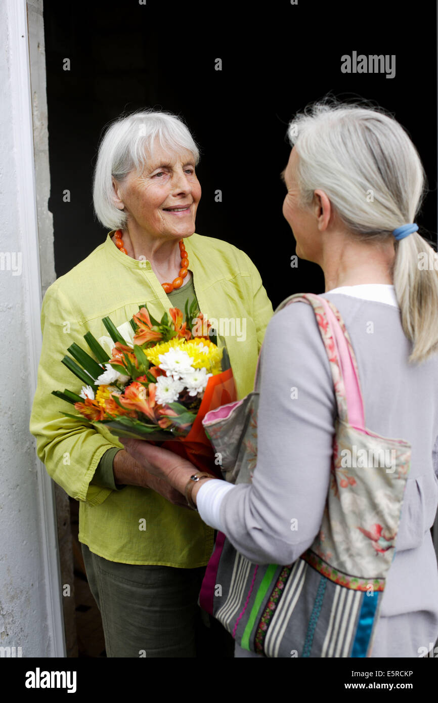 Elderly woman receiving a bouquet of flowers Stock Photo - Alamy