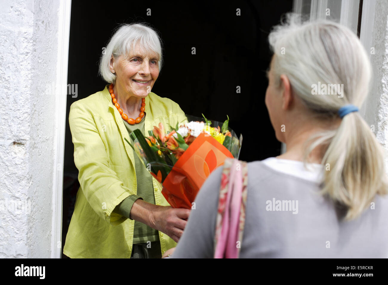 Elderly woman receiving a bouquet of flowers Stock Photo - Alamy