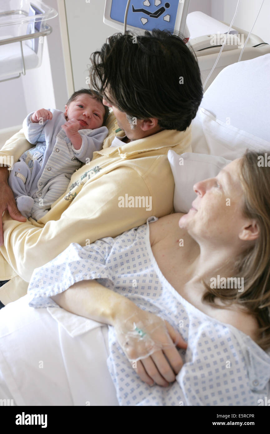 Couple with their newborn baby at maternity, Obstetrics and gynaecology ...
