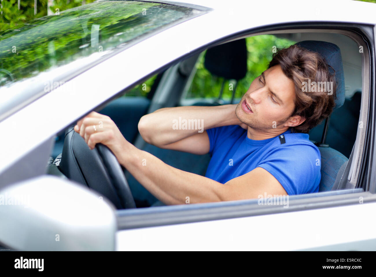 Driver suffering from neck pain Stock Photo - Alamy