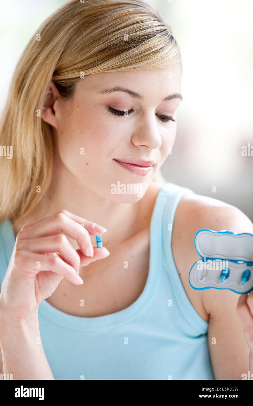 Woman taking Alli medicine, Alli is a half-dose version of the diet ...
