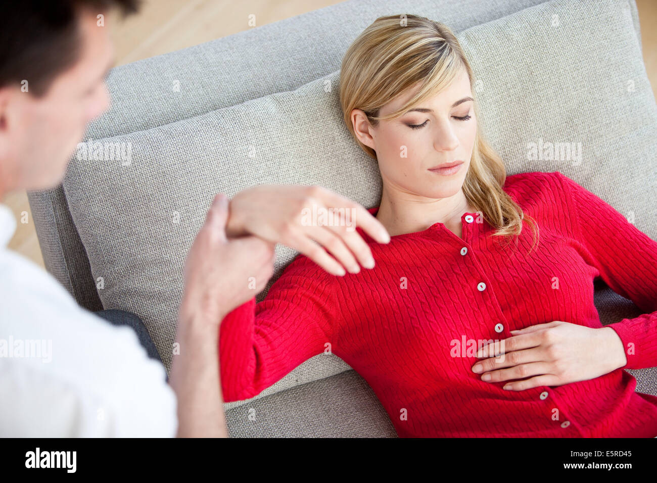 Woman undergoing ericksonian hypnosis, The hand in catalepsy indicates ...
