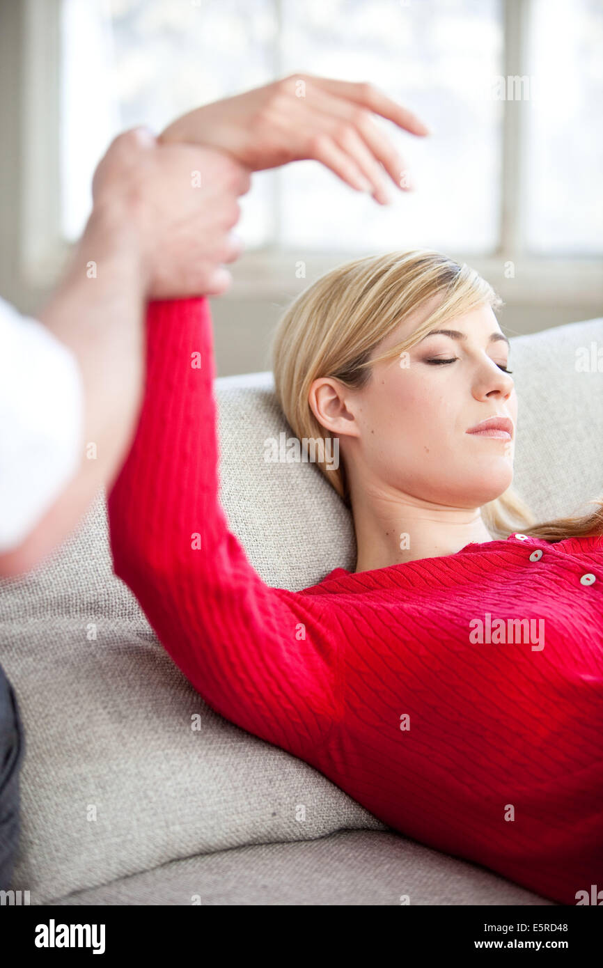 Woman undergoing ericksonian hypnosis, The hand in catalepsy indicates ...