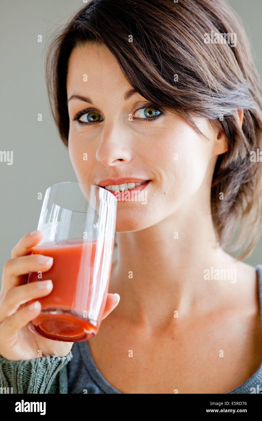 Woman drinking fruit smoothie Stock Photo - Alamy