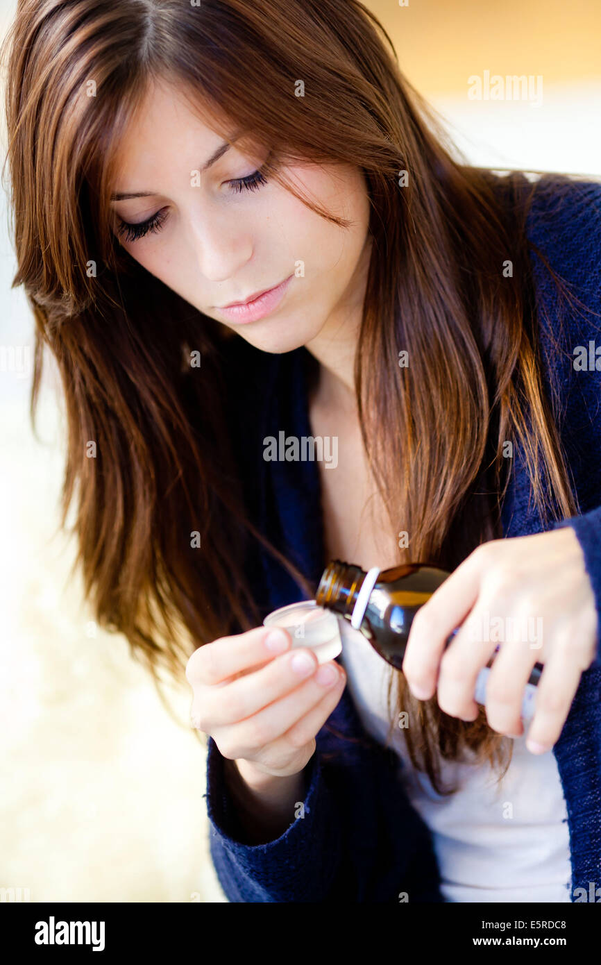 Woman taking syrup Stock Photo - Alamy