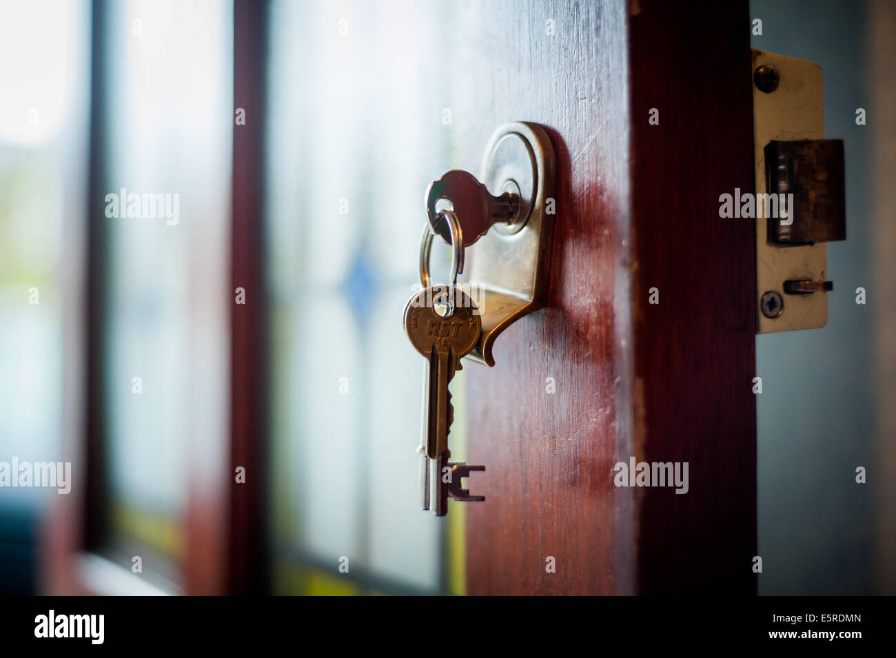 Key in a front door Stock Photo - Alamy