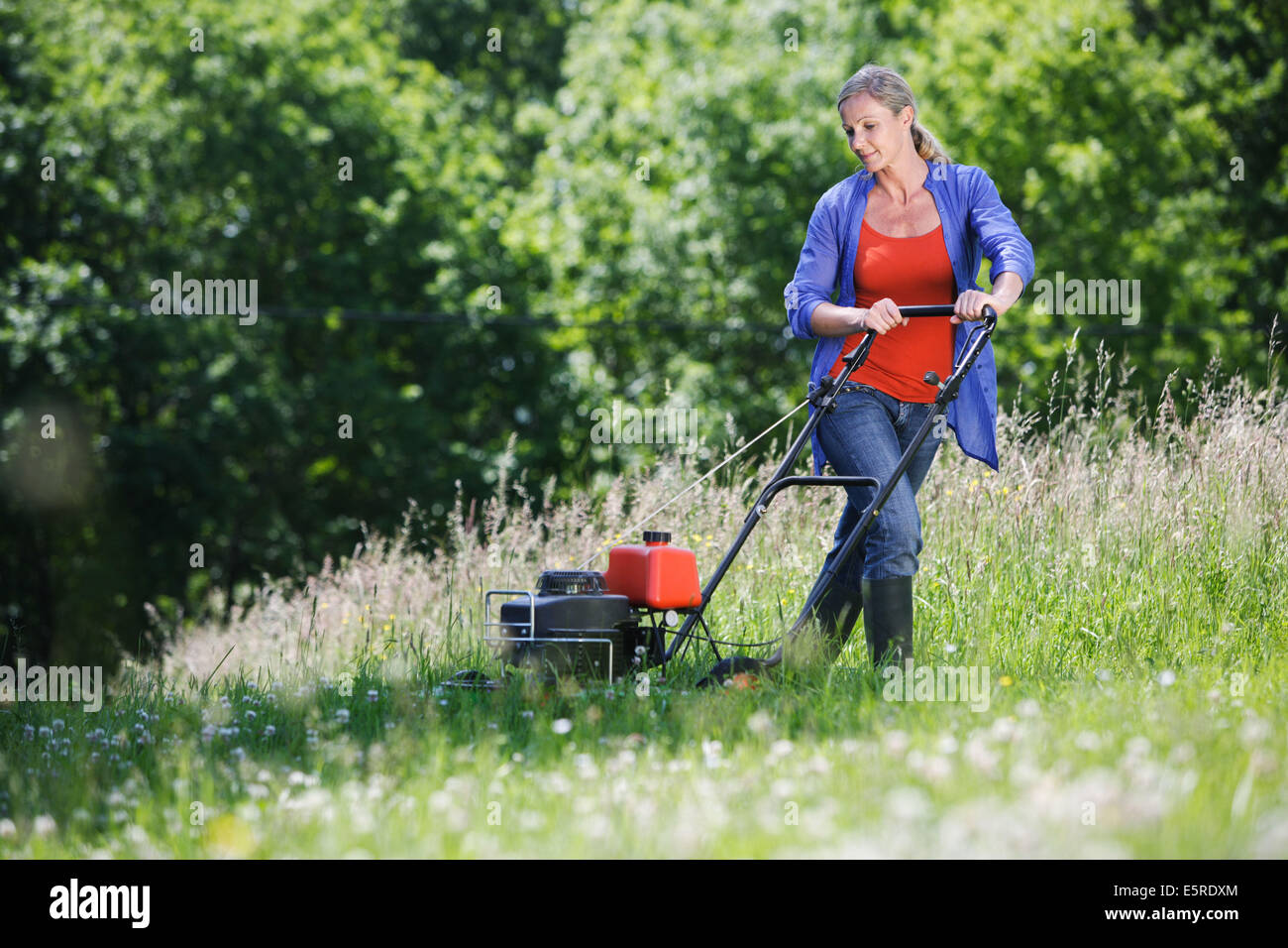 Woman using lawnmower hi-res stock photography and images - Alamy