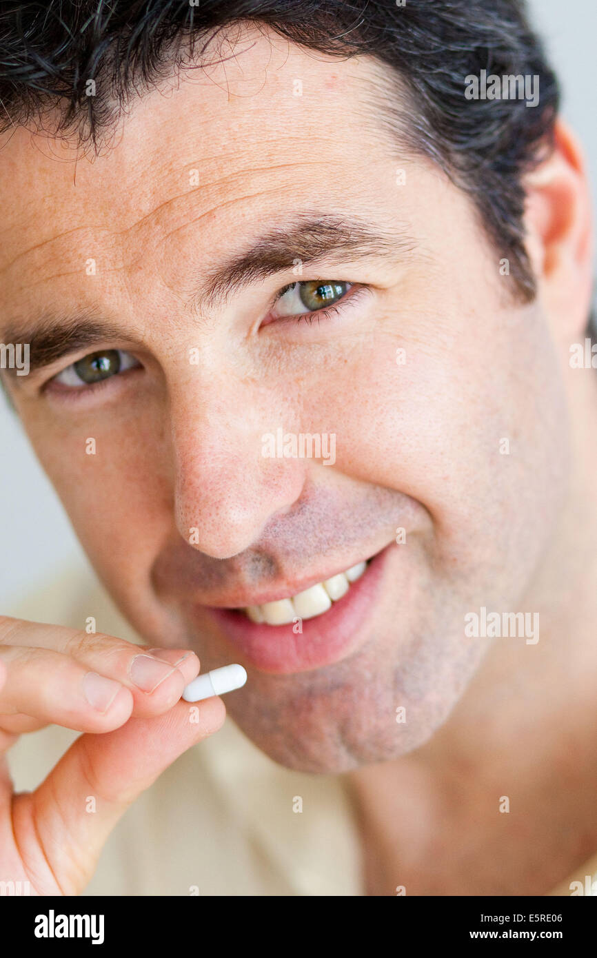 Man taking medication Stock Photo - Alamy