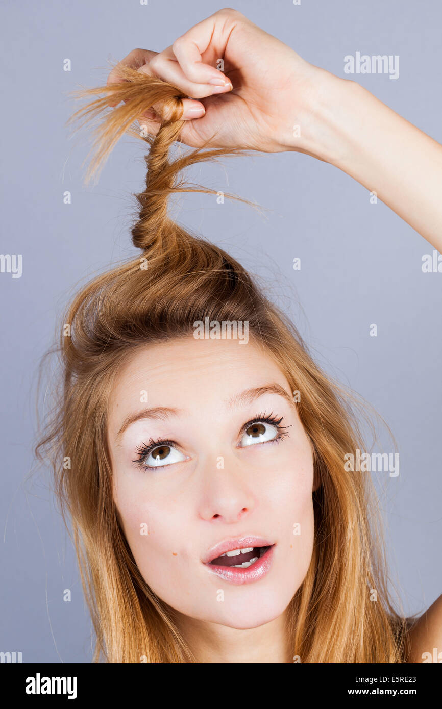 Woman touching her hair Stock Photo - Alamy