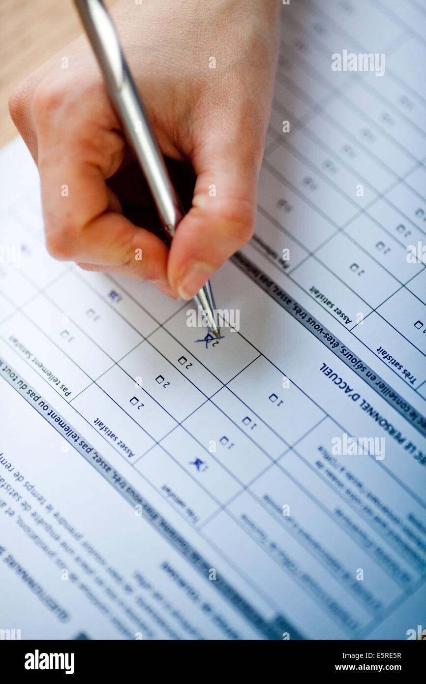 Woman filling questionnaire Stock Photo - Alamy