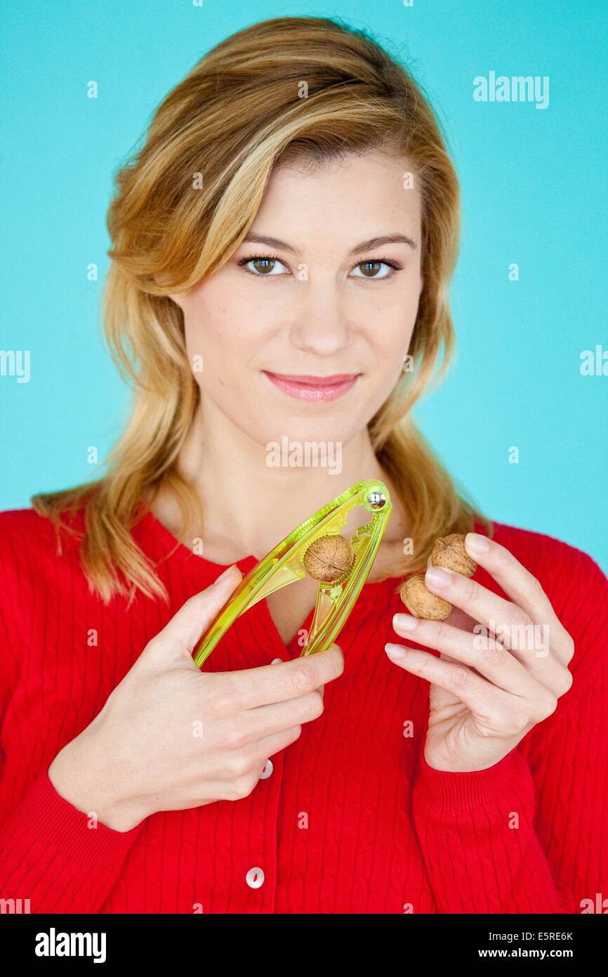 Woman eating walnuts Stock Photo - Alamy