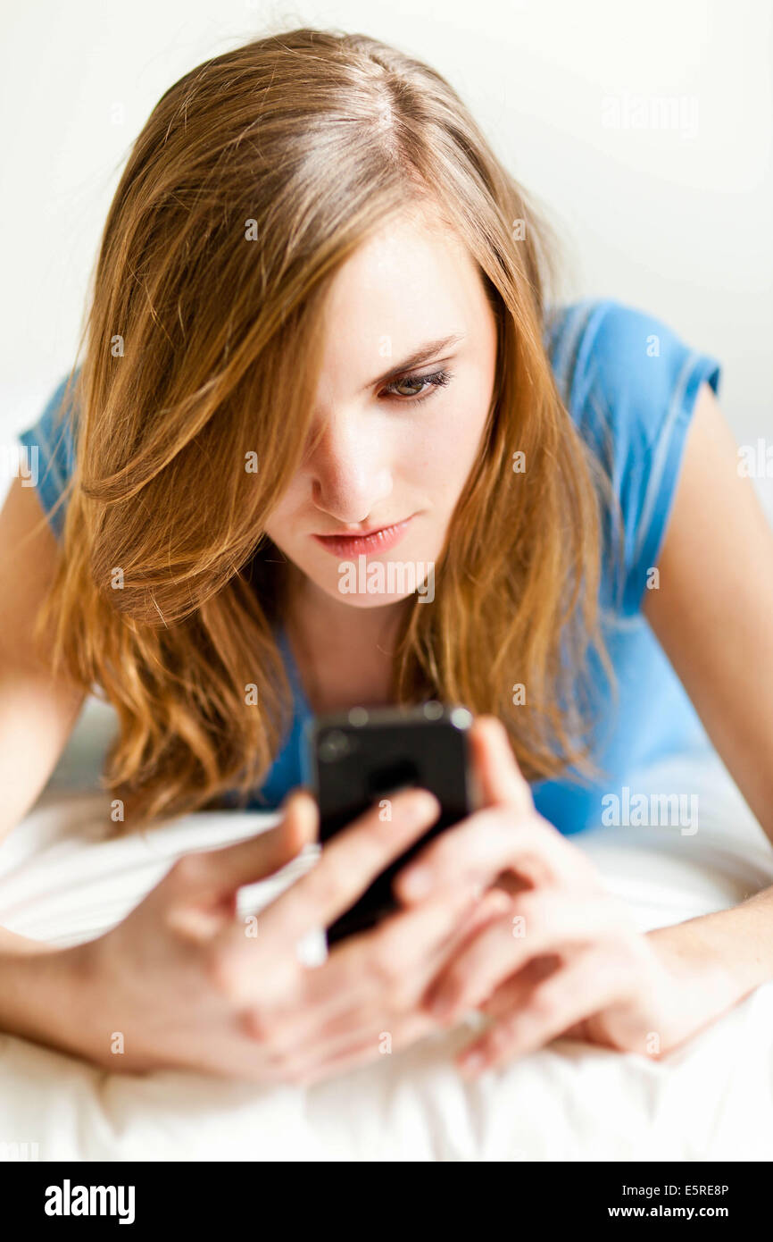 Woman touching the screen of an iphone® Stock Photo - Alamy
