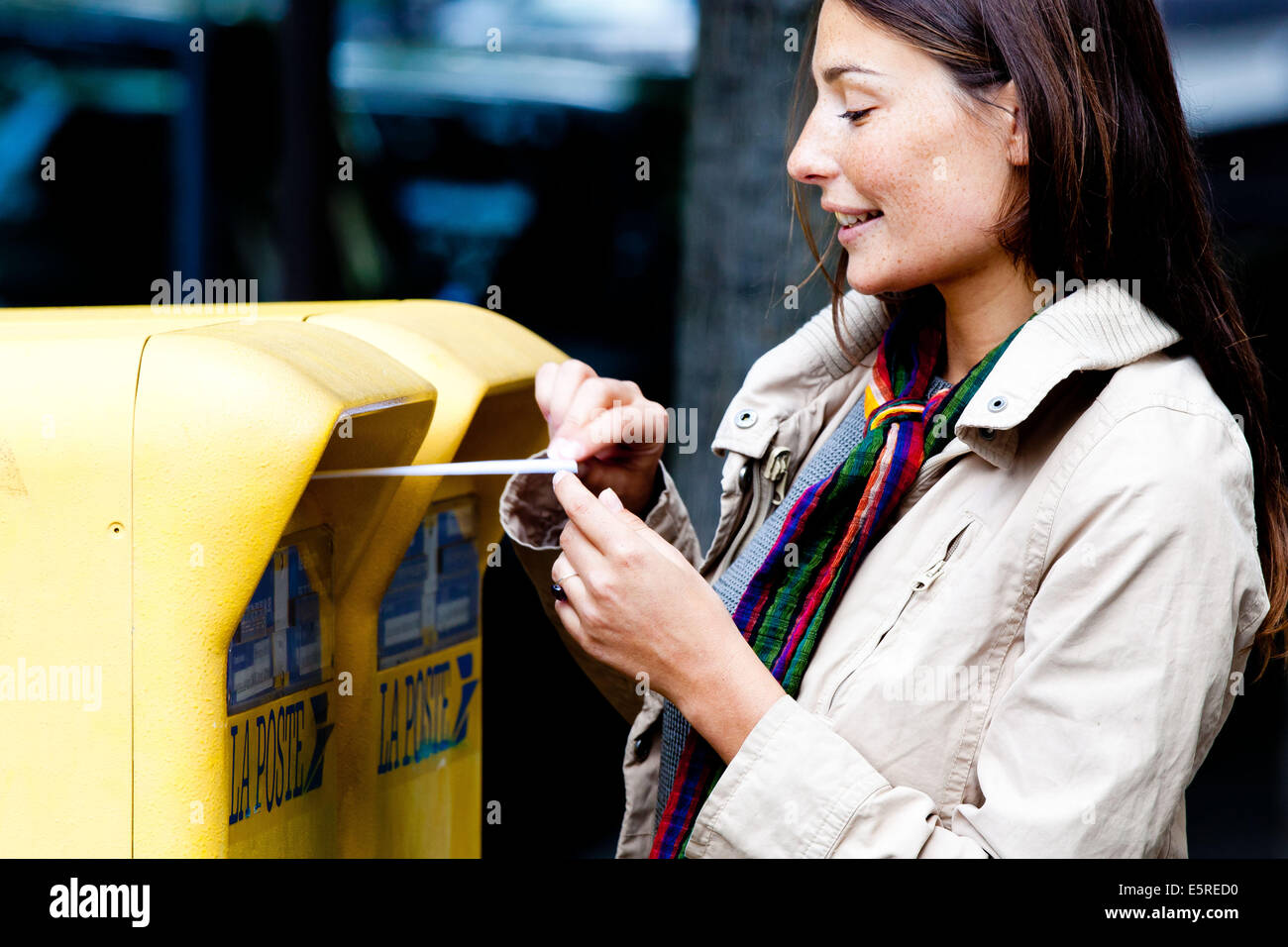 Woman posting letter Stock Photo - Alamy