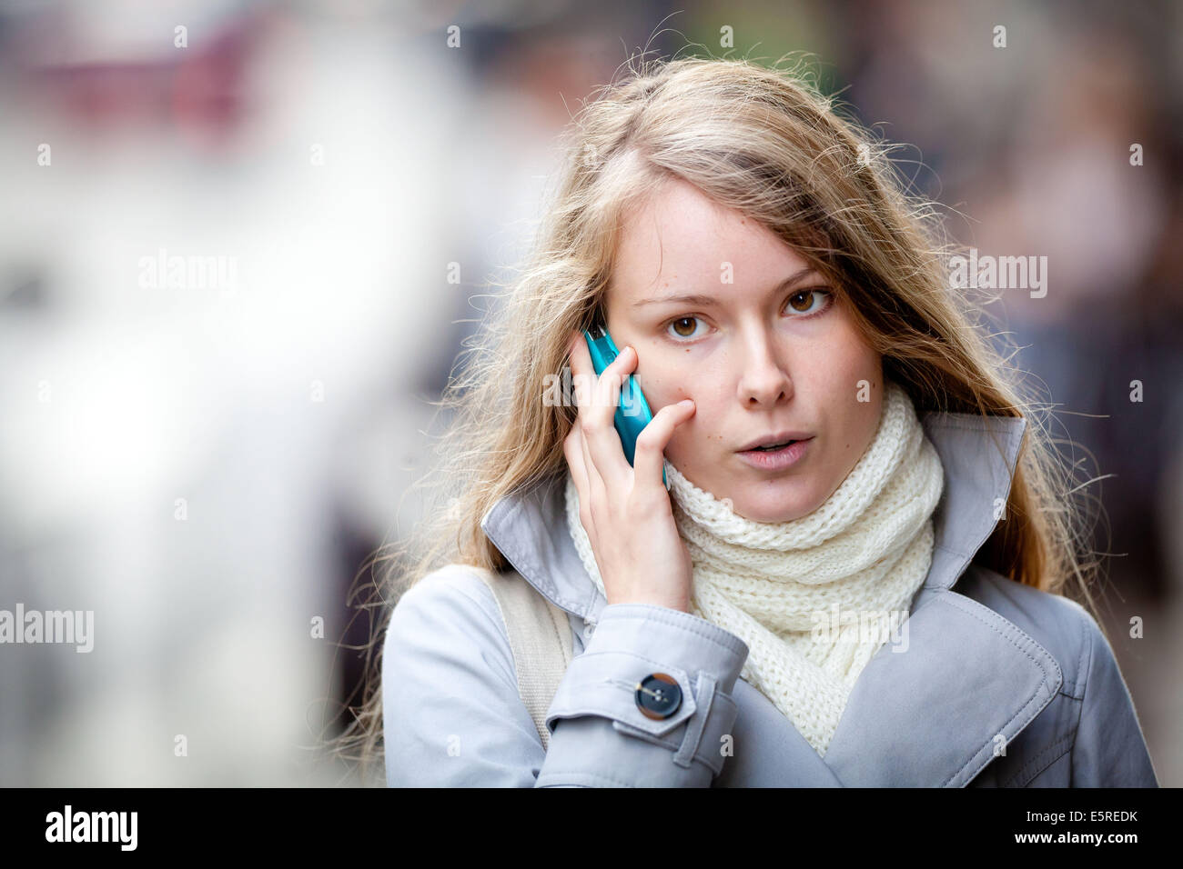 Woman using cell phone in the street Stock Photo - Alamy