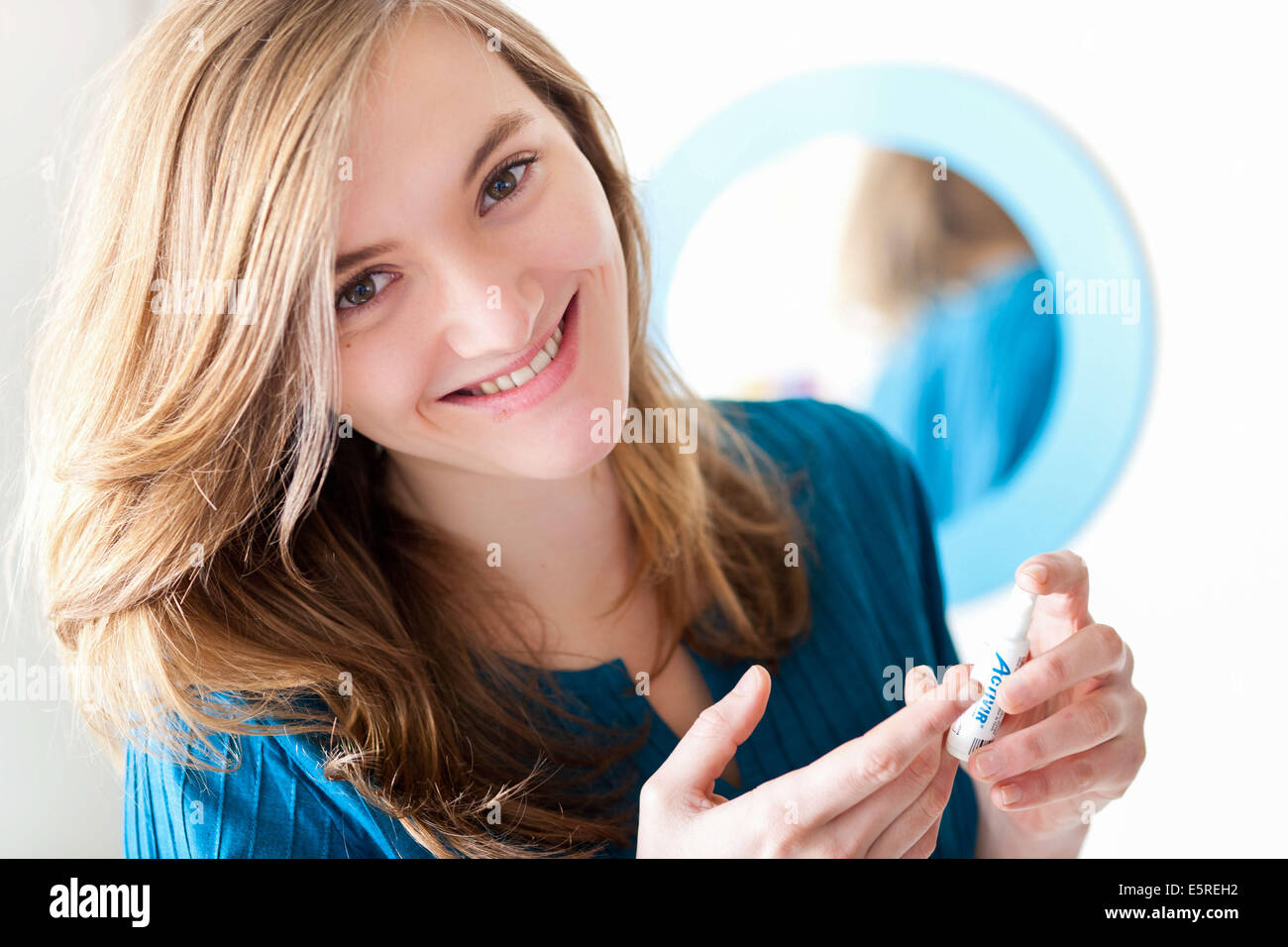 Woman applying cream on her lips as a treatment for a cold sore Stock ...