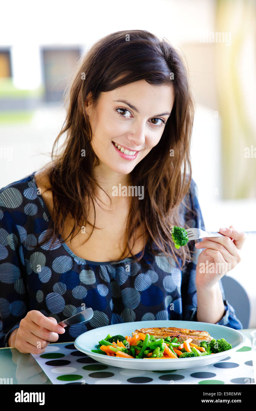 Woman eating fish and vegatables Stock Photo - Alamy
