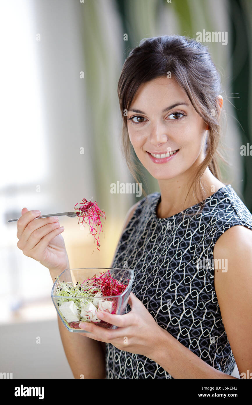 Woman eating sprouts Stock Photo - Alamy