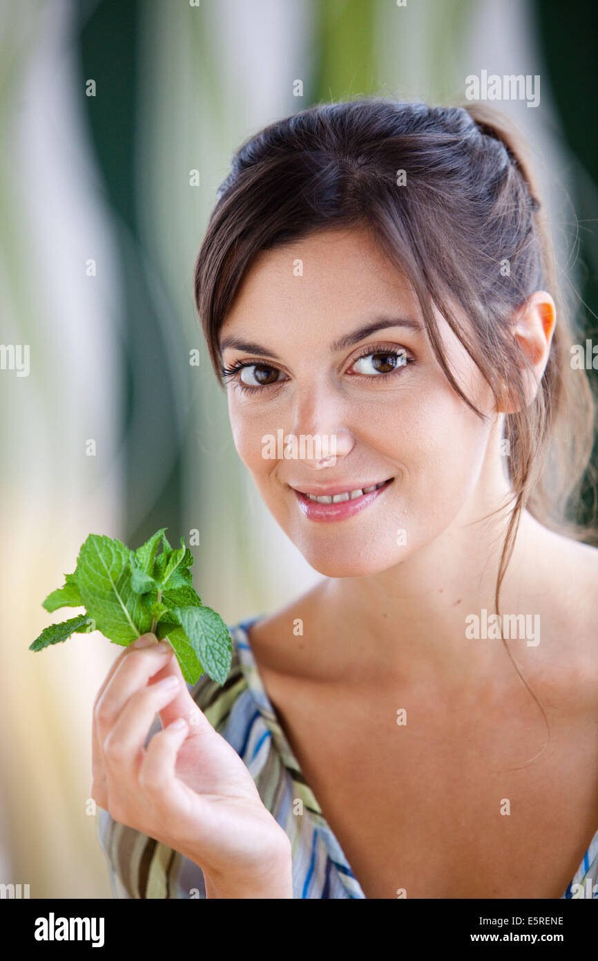 Woman smelling mint leaves (Mentha sp Stock Photo - Alamy