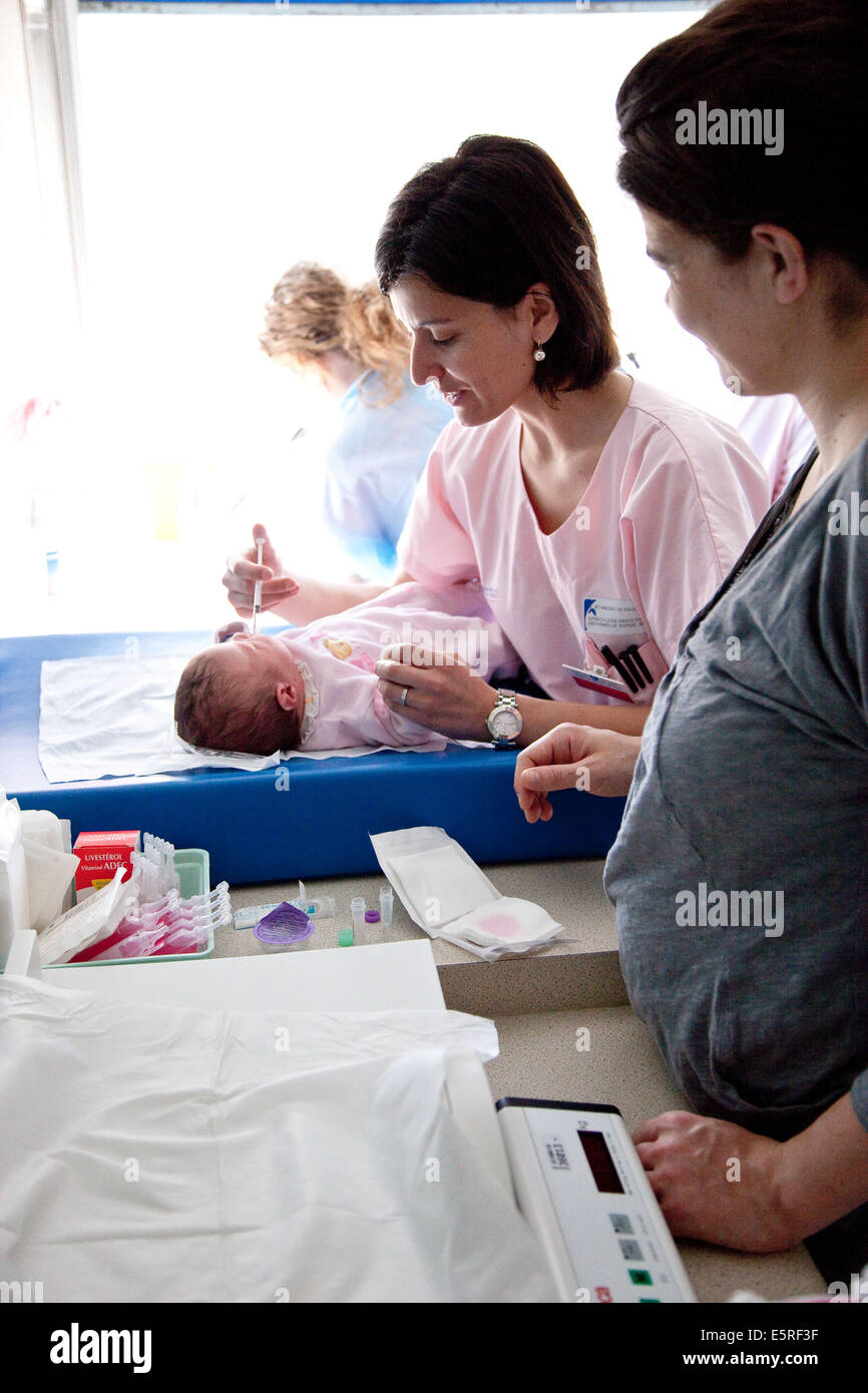 Midwife taking care of a newborn baby, Maternity department, Cochin ...