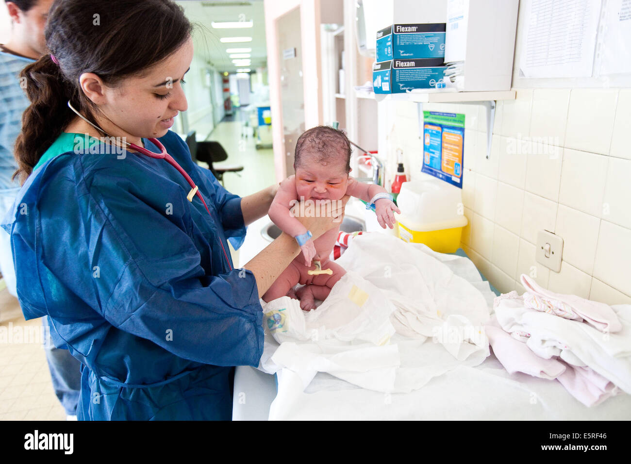 Midwife taking care of a newborn baby, Maternity department, Cochin ...