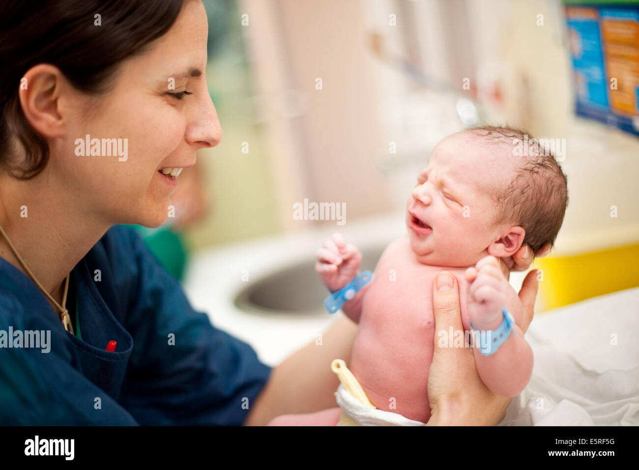 Midwife taking care of a newborn baby, Maternity department, Cochin ...