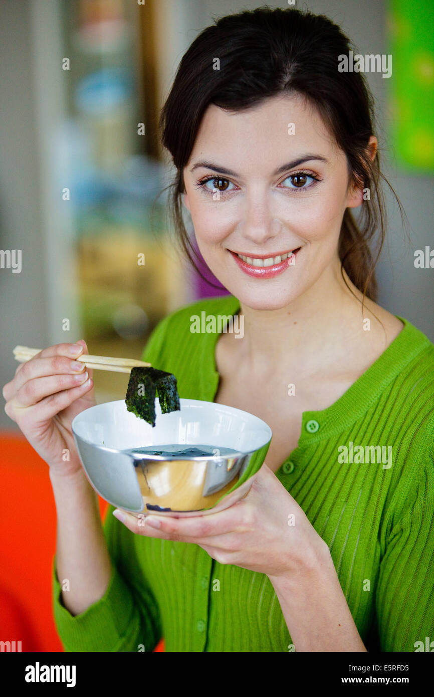 Woman eating edible seaweed Stock Photo - Alamy