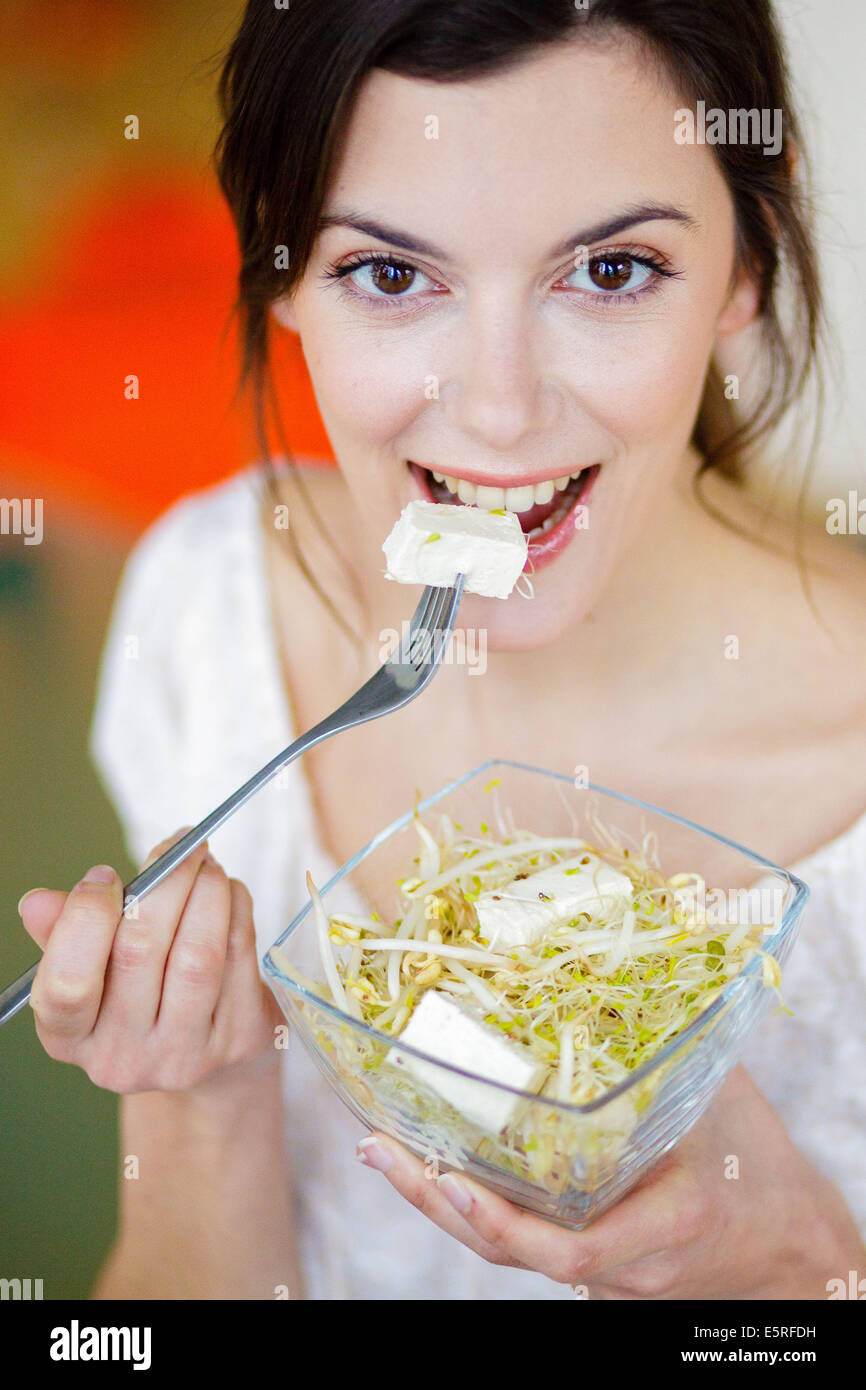 Woman eating tofu Stock Photo - Alamy