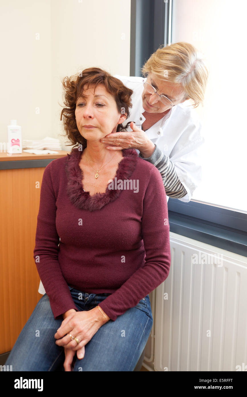 Cancer radiotherapist with a female patient suffering from throat ...