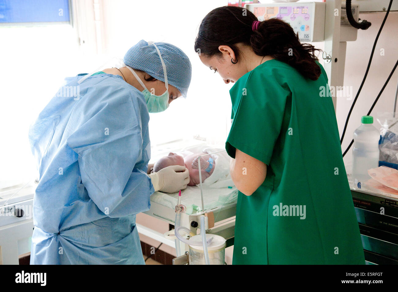 Midwives taking care of a newborn baby, Maternity department, Cochin ...
