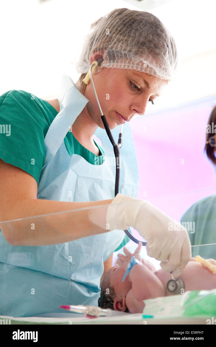 Midwife taking care of a newborn baby, Maternity department, Cochin ...