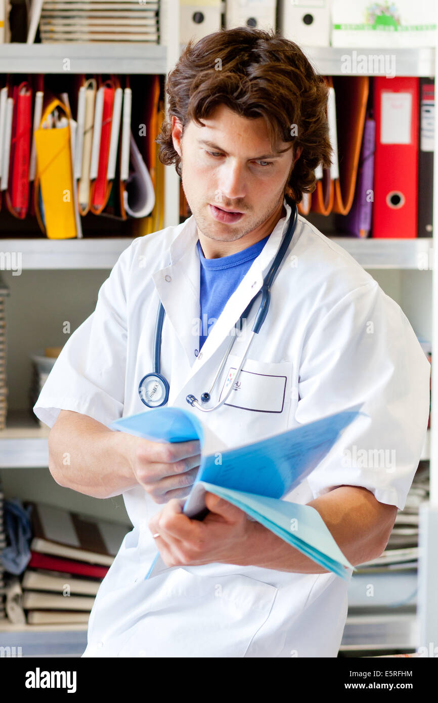 Doctor reading medical records in a hospital Stock Photo - Alamy