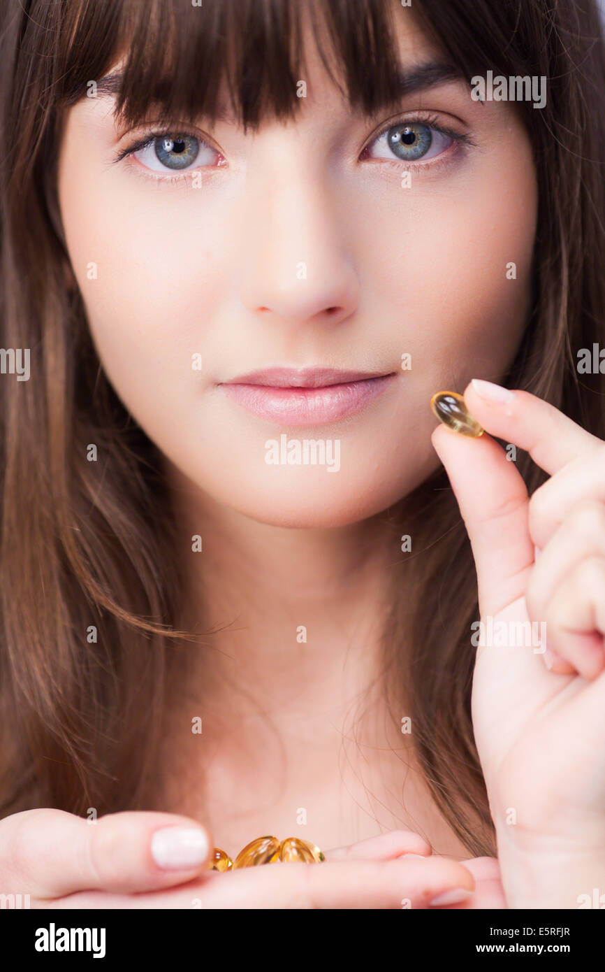 Woman taking food supplement capsules Stock Photo - Alamy