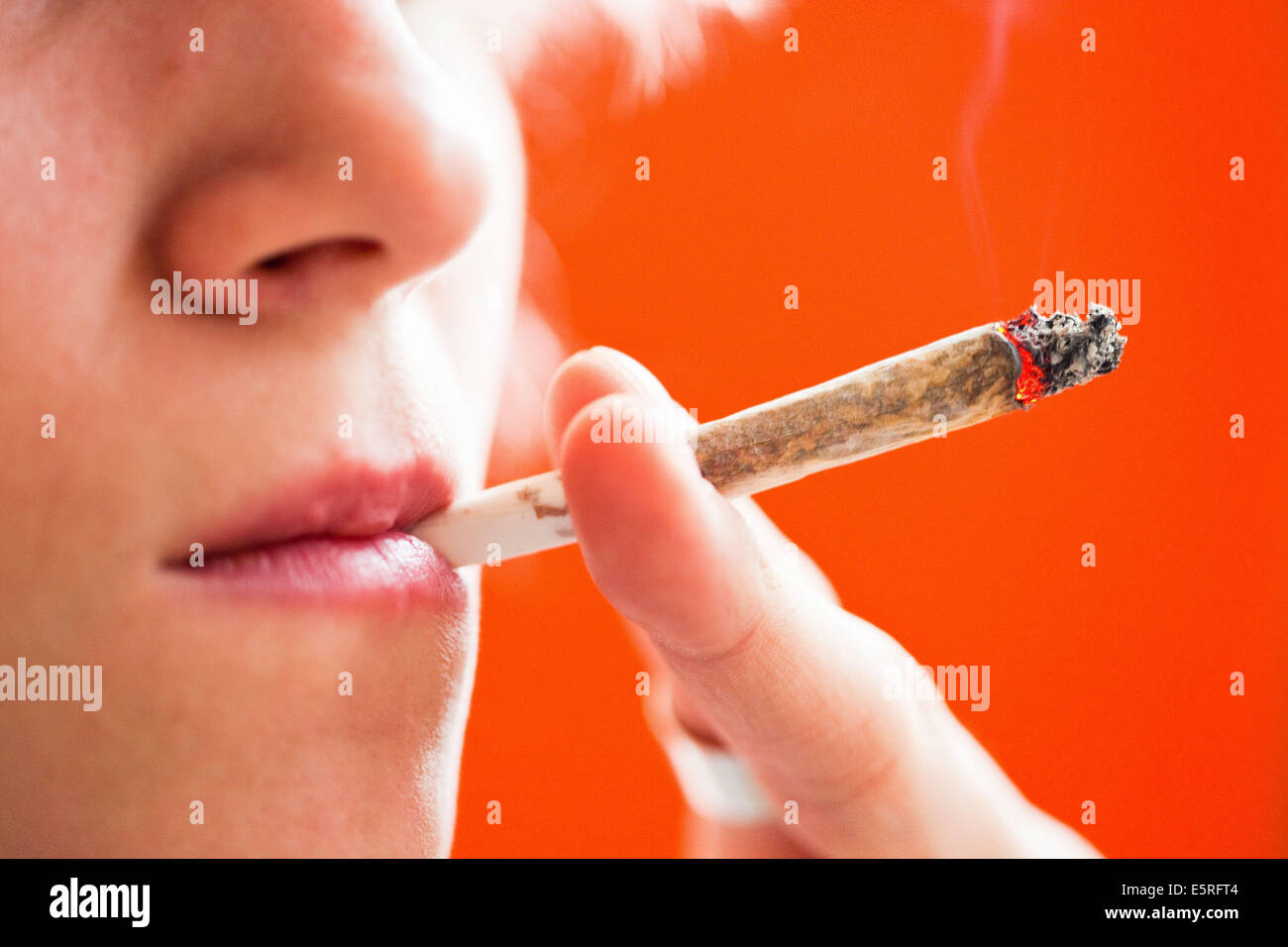 Teenage girl smoking marijuana or hashish cigarette Stock Photo - Alamy