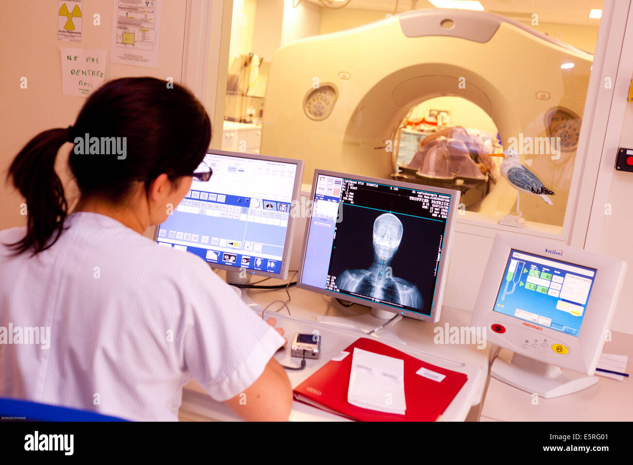 Radiotherapy radiographer, Male brain cancer patient during a computed ...