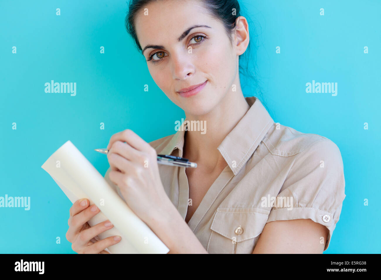 Woman writing in her diary Stock Photo - Alamy